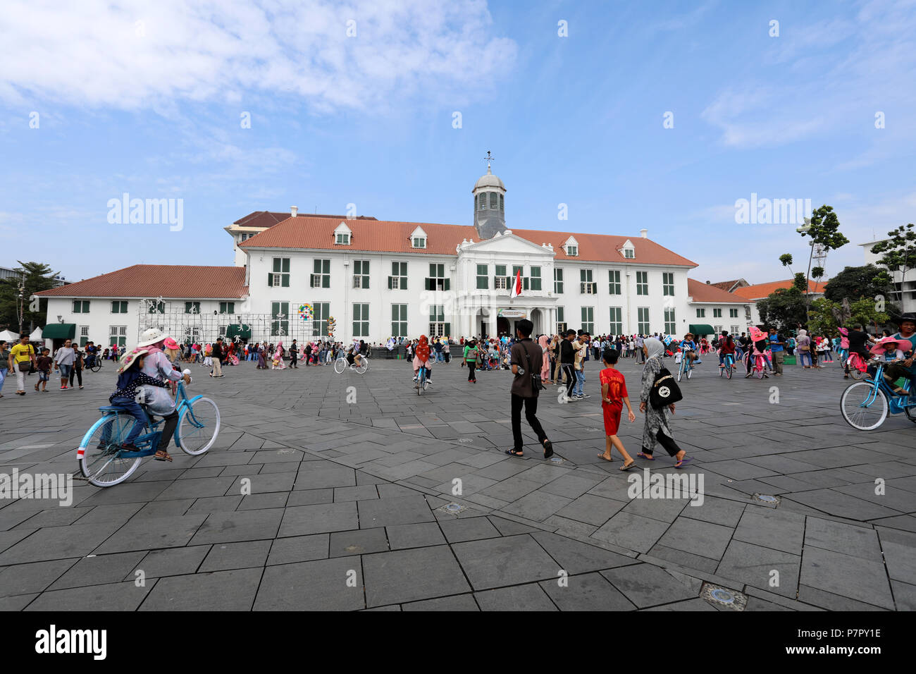 Jakarta, Indonesia - June 20, 2018: Locals walk and cycle through ...