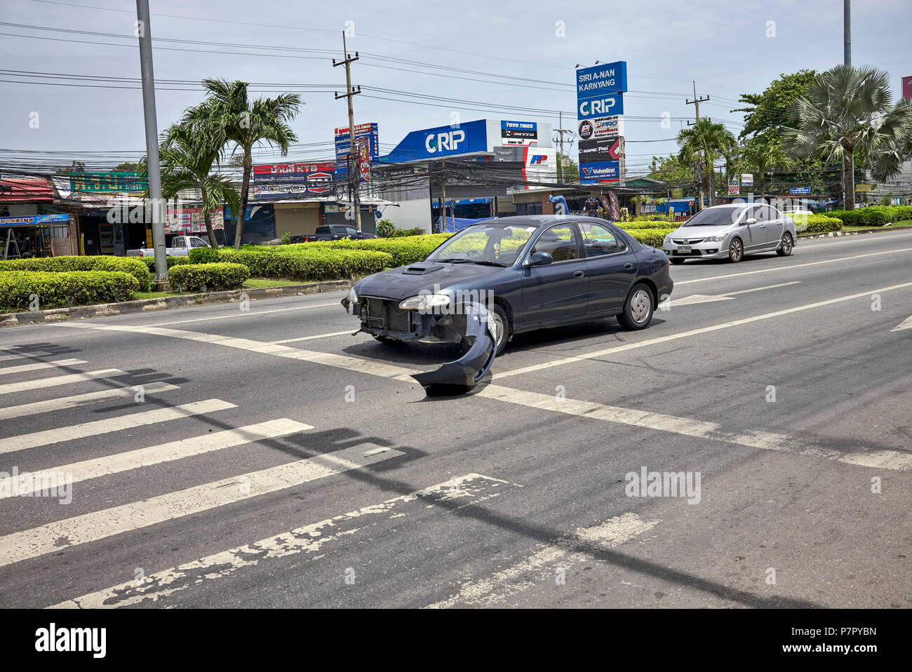 Road accident. Car with the front bumper ripped off following a ...