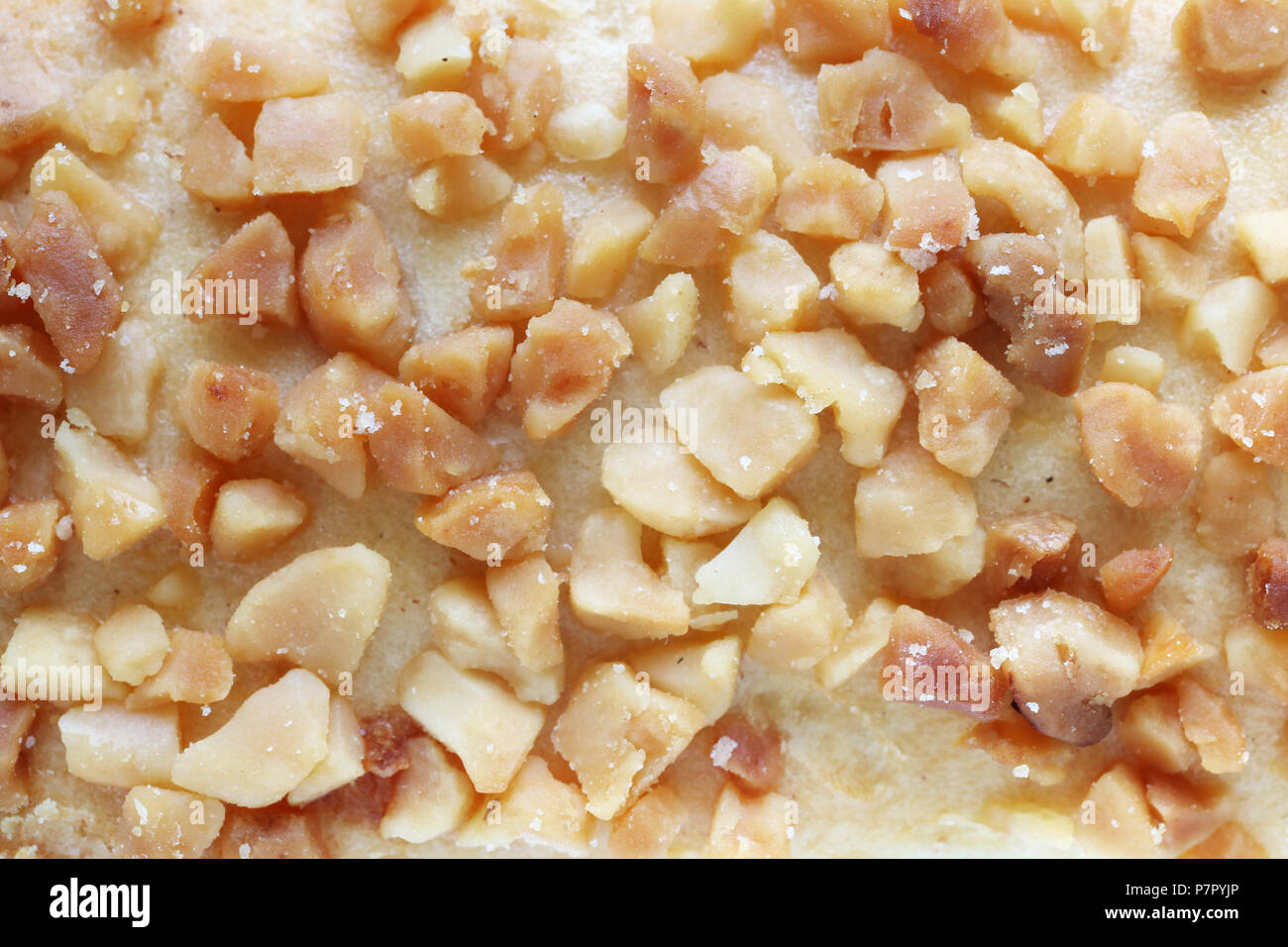 Sliced roasted peanuts on the surface of a shortbread cookie. Studio ...