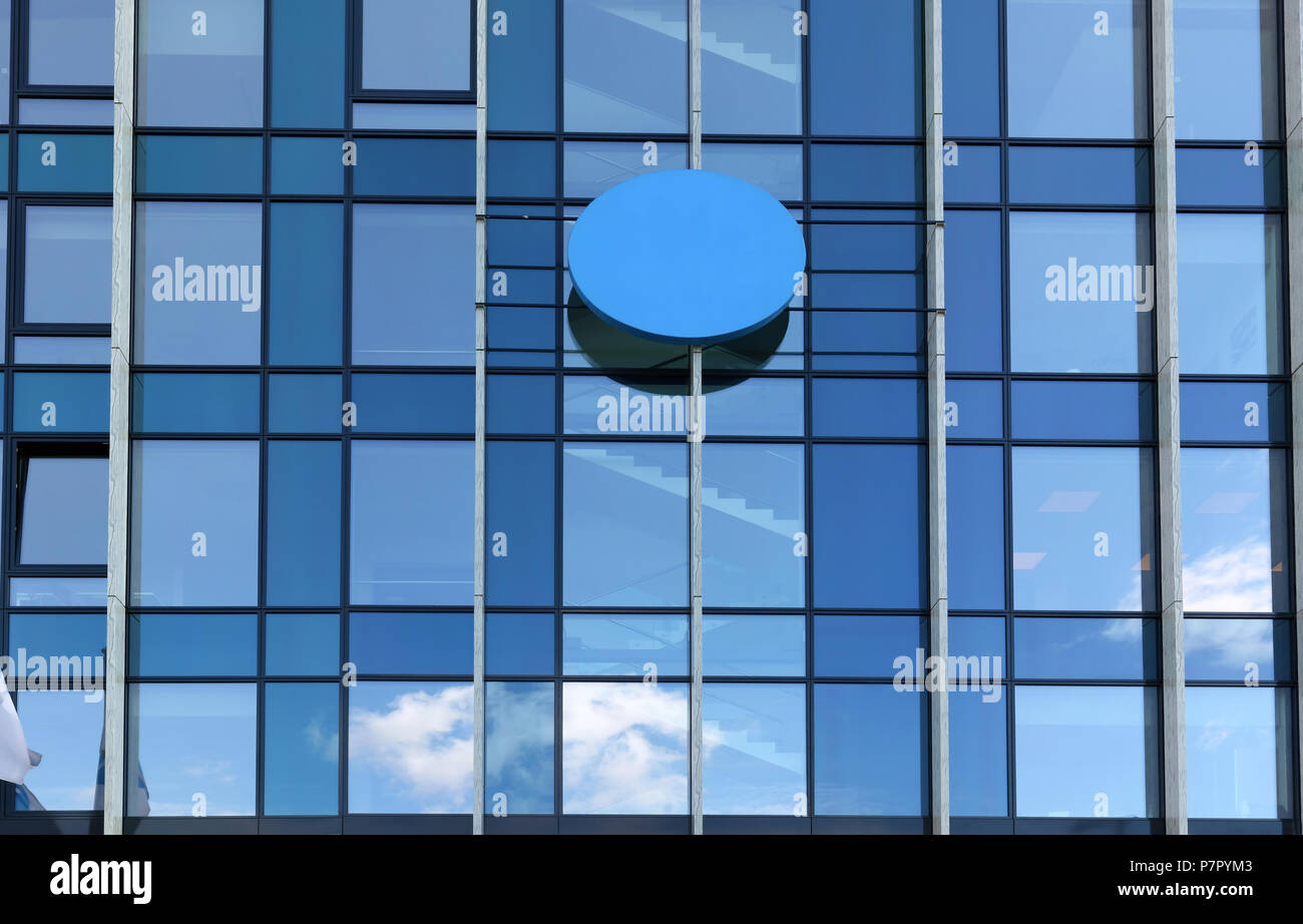 Reflections of the blue sky in the windows of a standard office ...