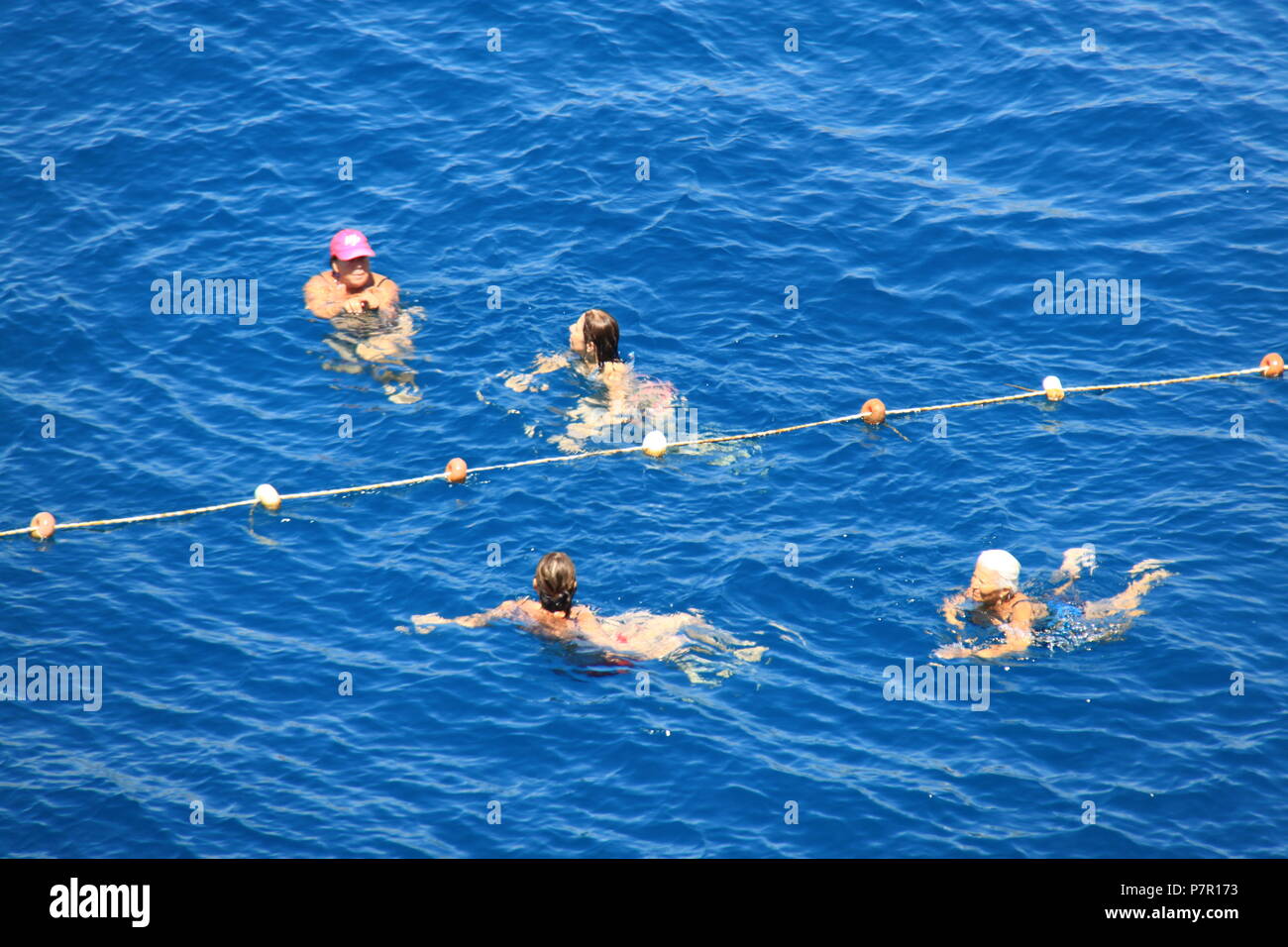 Holidaymakers swimming offshore from the Byzantine Castle built on ...