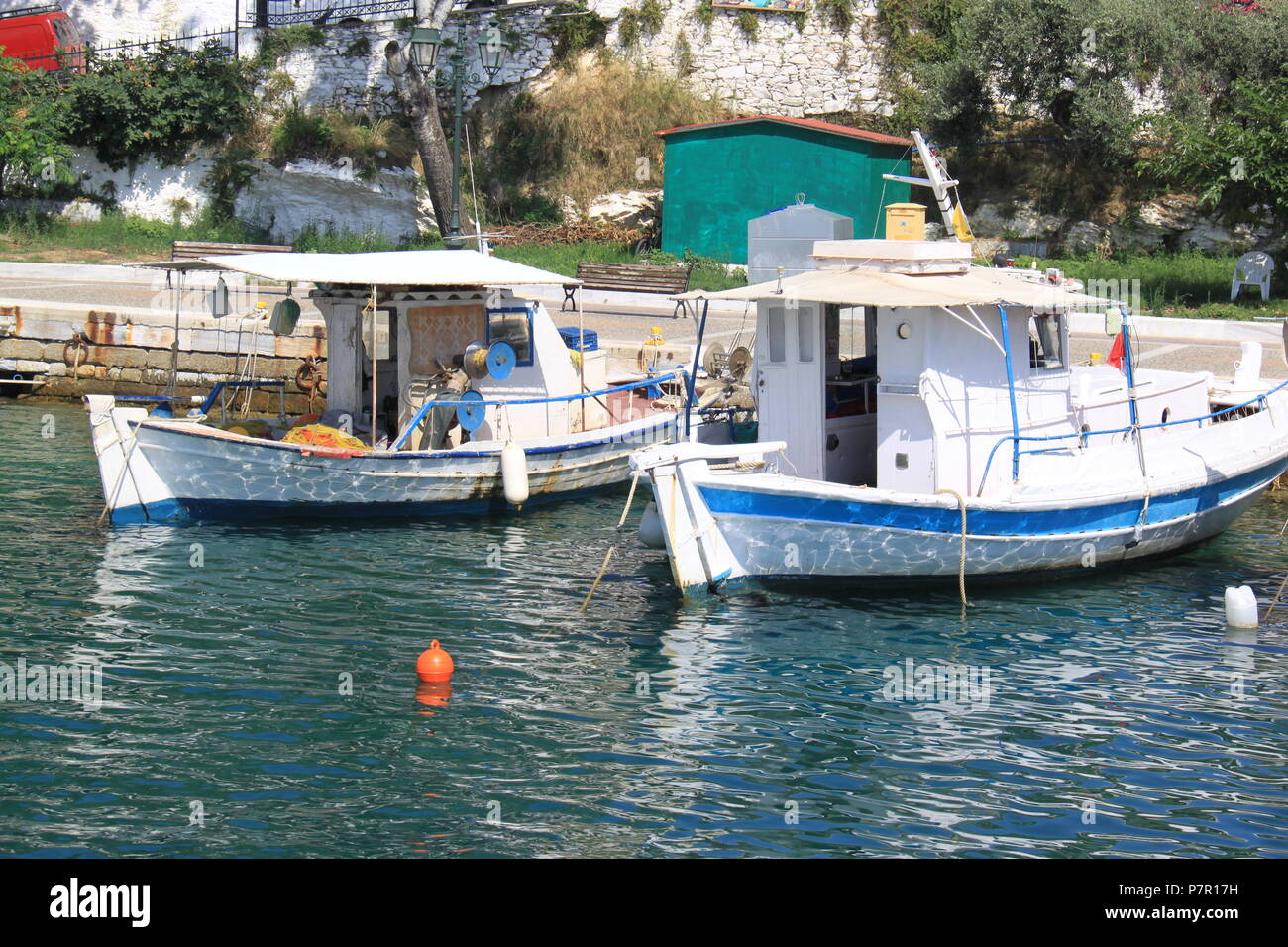 Local fishing boats moored in the old harbour at Skiathos Town ...