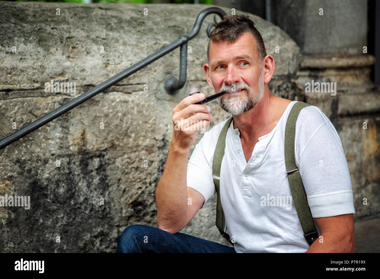 portrait of handsome bearded man in his 50s smoking a pipe Stock Photo ...