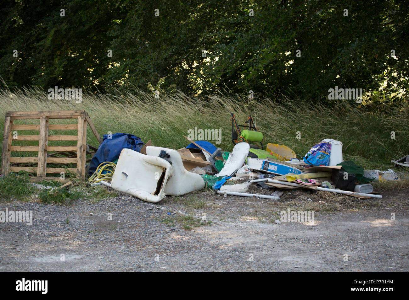 Rubbish dumped in the entrance to a field next to a rural road in ...