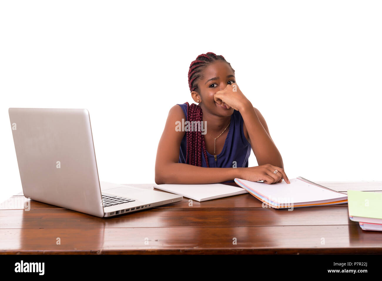 Young african student working with her laptop, isolated over a white ...