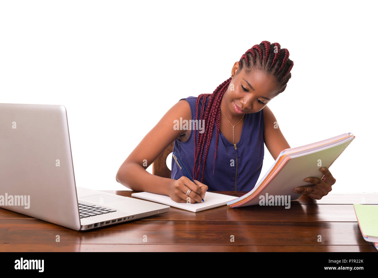 Young african student working with her laptop, isolated over a white ...