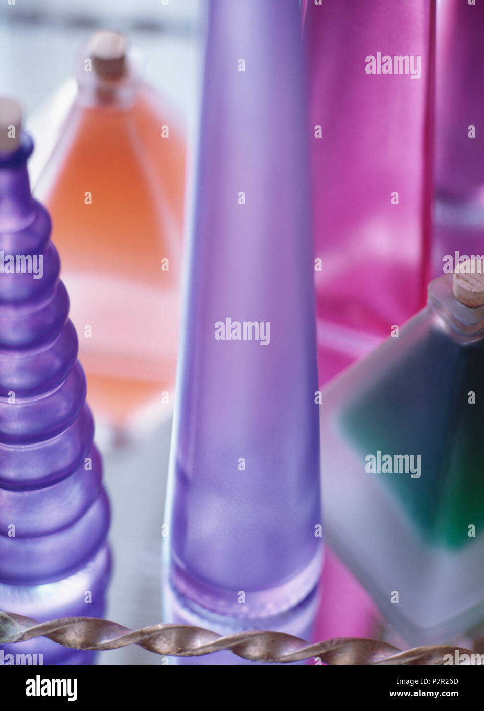 Close-up of spiral and conical purple glass bottles Stock Photo - Alamy