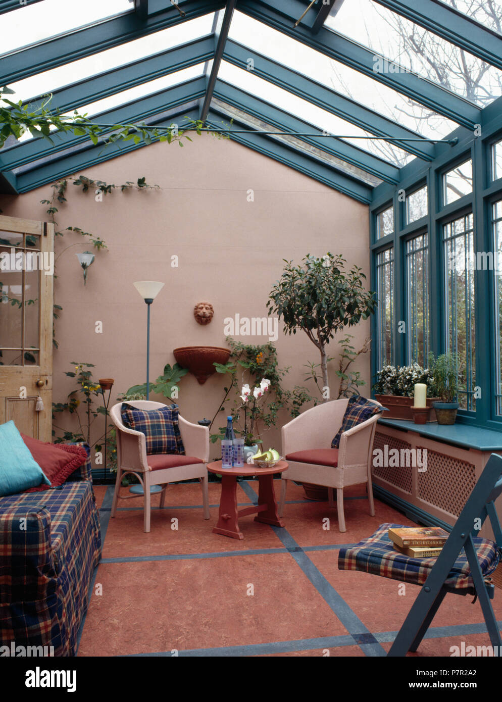 White wicker chairs in a conservatory with blue paintwork Stock Photo ...