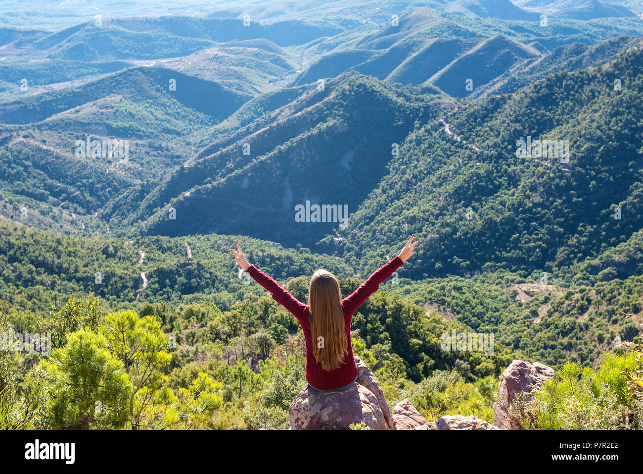 Beautiful women showing peace sign while enjoying mountains landscape ...