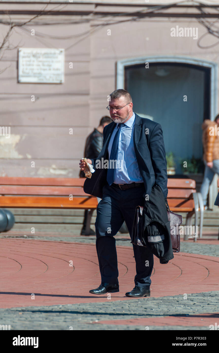 TIMISOARA, ROMANIA - MARCH 15, 2018: Business man walking on the street ...