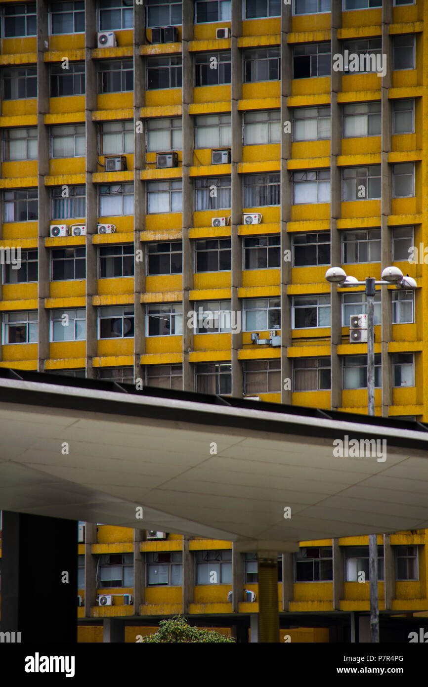 Yellow office old building with modern metallic structure in front ...