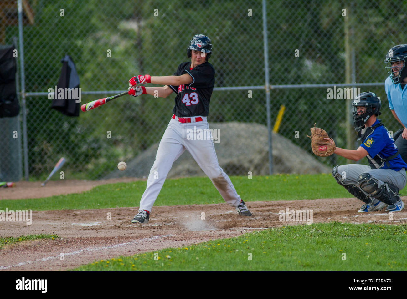 Batter hitting foul ball, ball bounces in front of plate, boys ...
