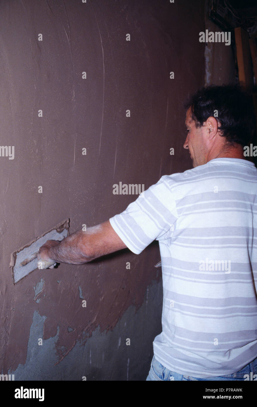 Man plastering a wall FOR EDITORIAL USE ONLY Stock Photo - Alamy