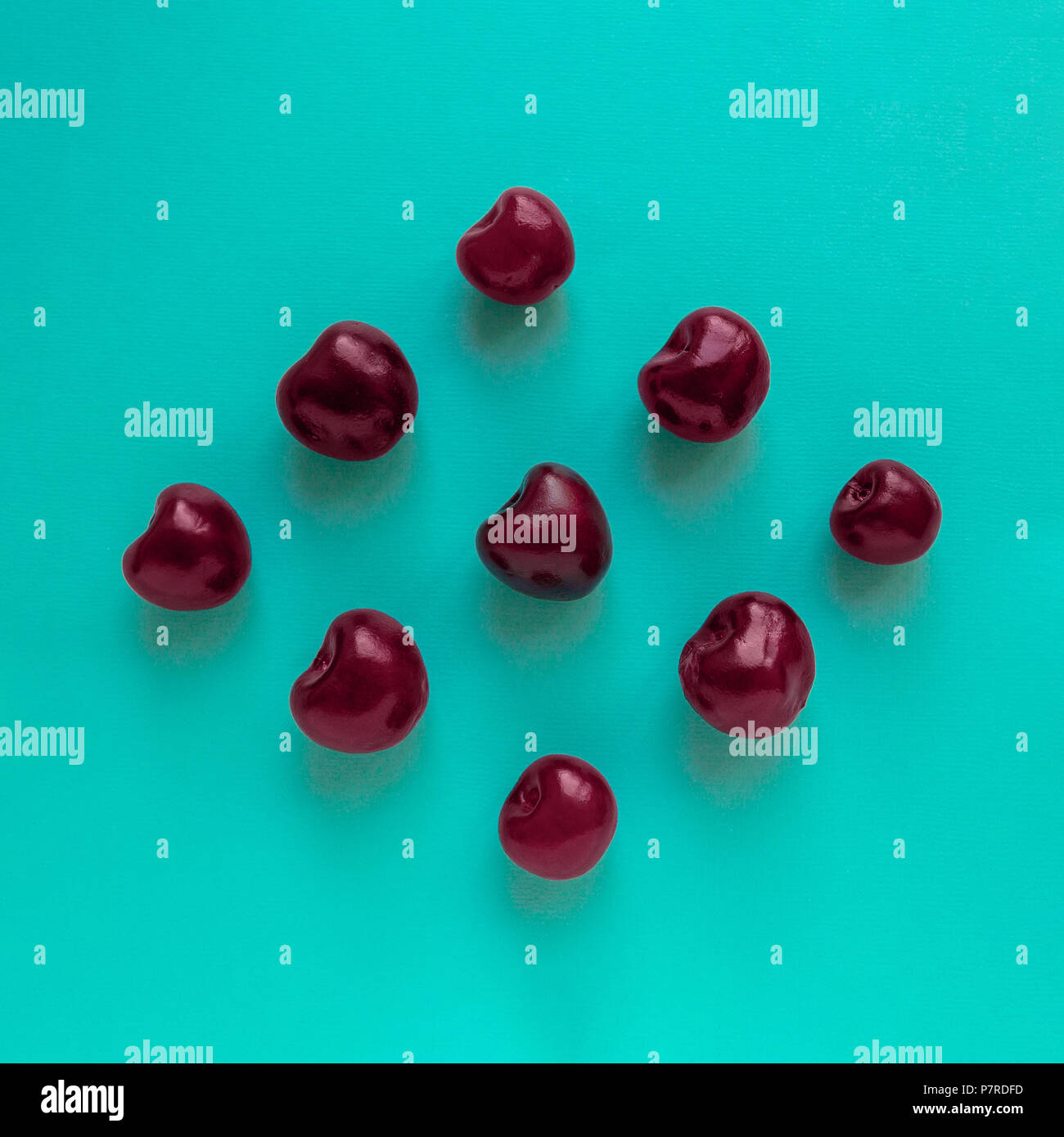 Cherry Top view Ripe cherries are lying in the diamond shape on blue ...