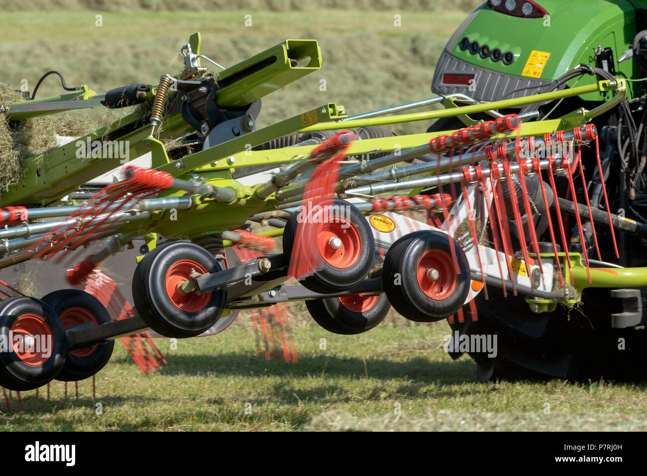 Dartmoor, Devon, England, UK Haymaking on a Devonshire farm using a Claas Liner swath laying ...