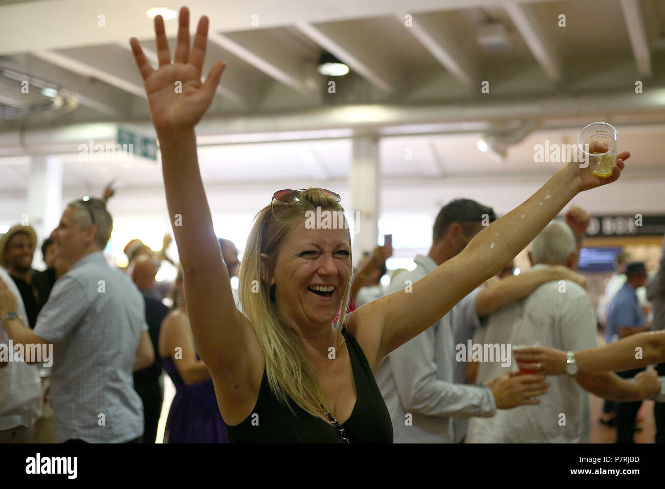 Racegoers watch the FIFA World Cup quarter final between England and ...