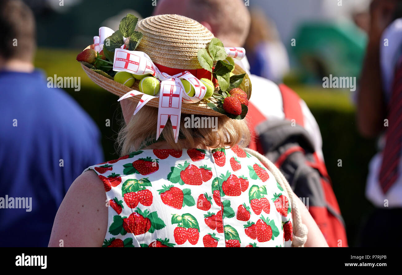 A tennis fan wears a strawberry hat and dress on day six of the ...