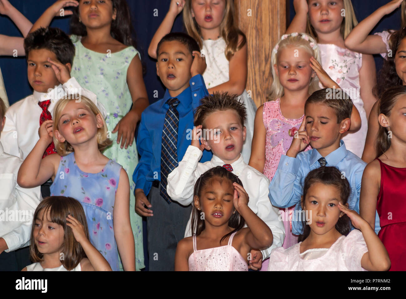 Group of Kindergarten kids perform for parents in audience. © Myrleen ...