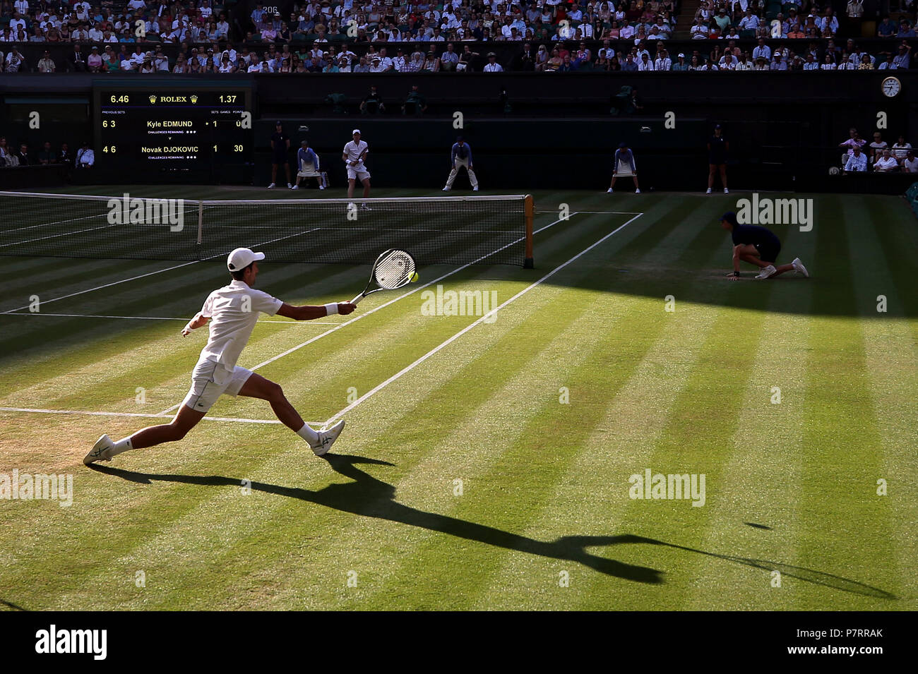 Novak Djokovic and Kyle Edmund in action on centre court on day six of ...