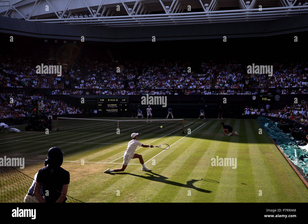 Novak Djokovic and Kyle Edmund in action on centre court on day six of ...