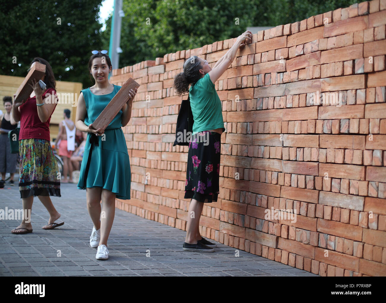 Visitors help to dismantle and take a brick from Mexican artist Bosco ...
