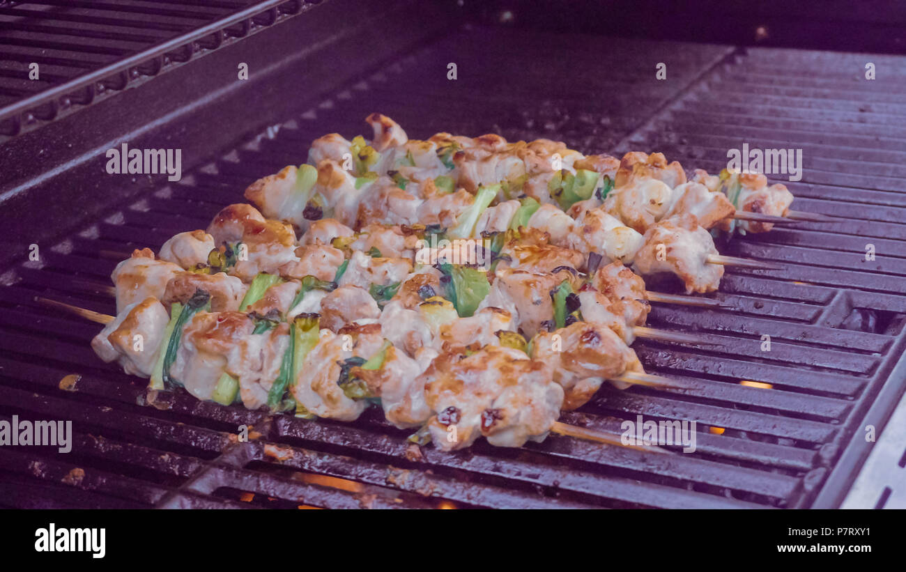 Step by step. Chicken yakitori on a white metal serving tray next to ...
