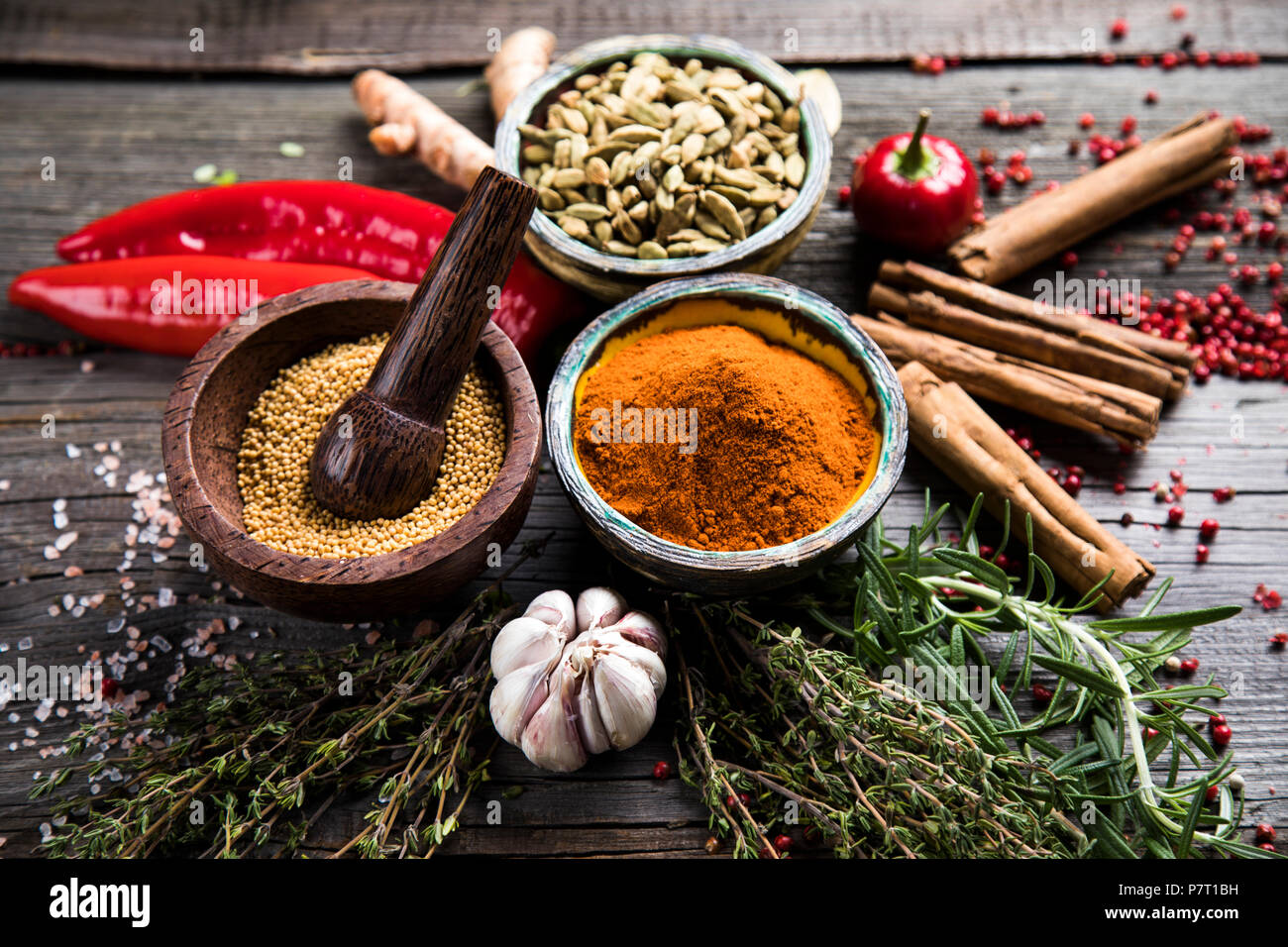Wooden table of colorful spices Stock Photo - Alamy