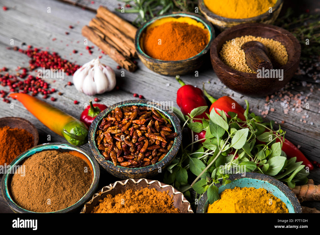 Wooden table of colorful spices Stock Photo - Alamy