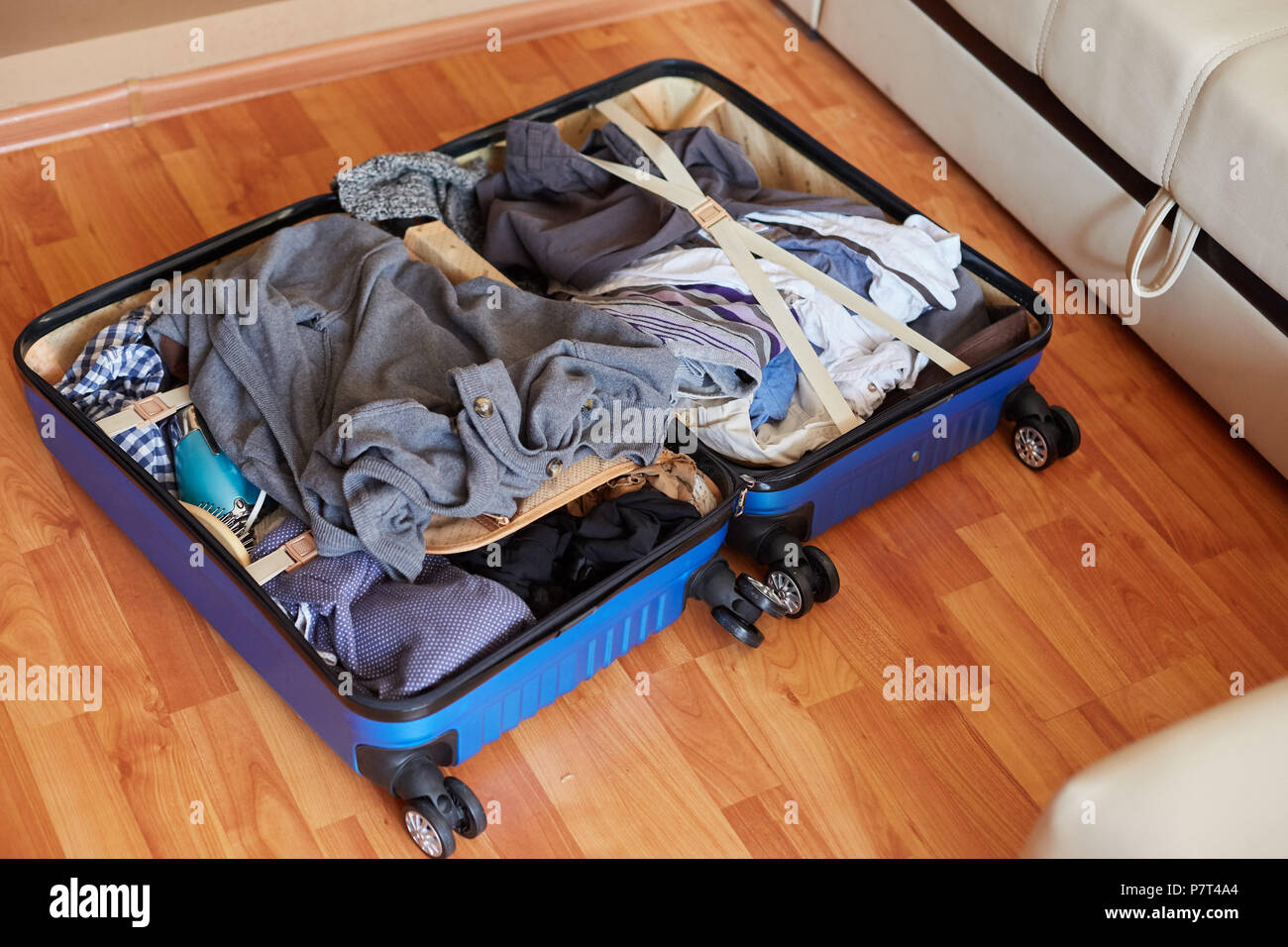 Open suitcase packed for travelling, close up Stock Photo - Alamy