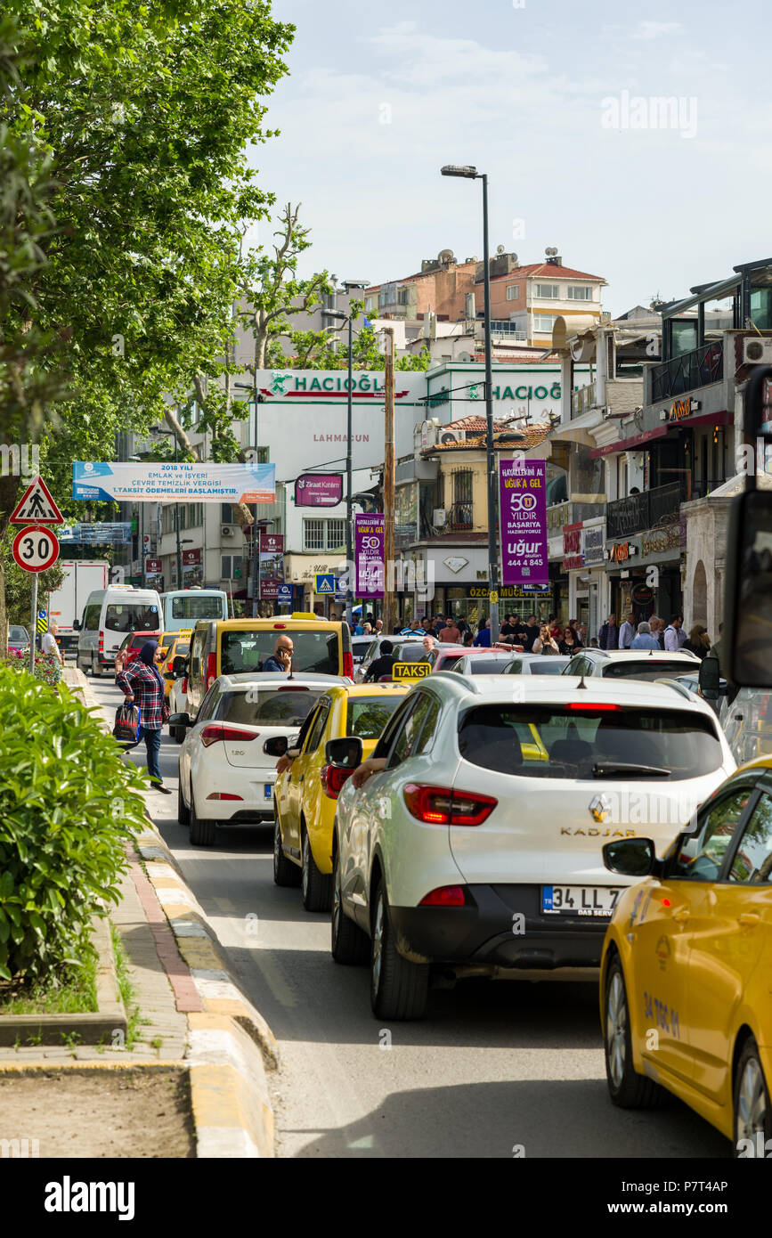 A road with lots of vehicles queued in a small traffic jam with ...