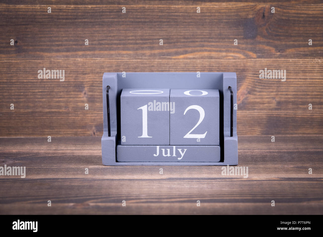 12 July. Wooden, square calendar. business trip or holiday planning ...