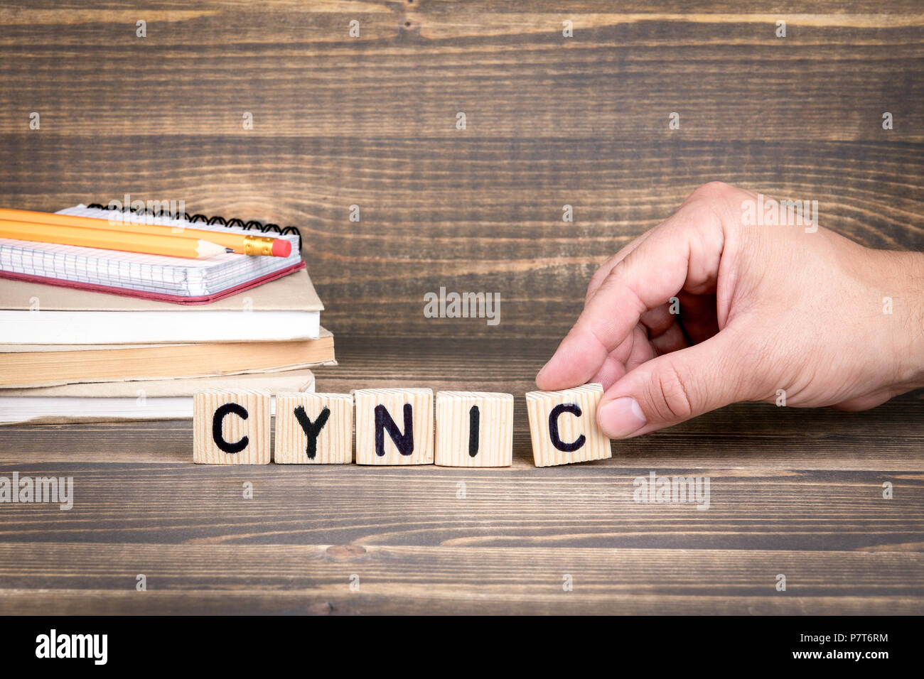 cynic. Wooden letters on the office desk, informative and communication ...