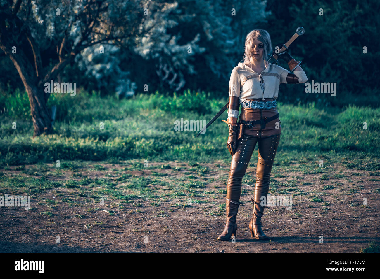 Fantasy cosplay beautiful Witcher girl with sword Stock Photo - Alamy