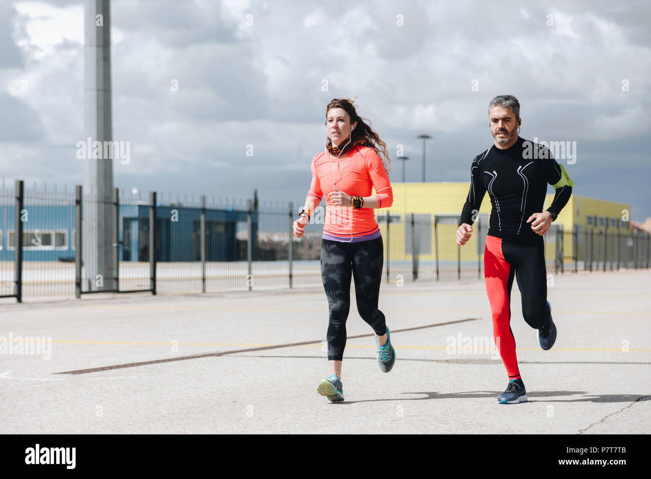 young adults couple running together in the street Stock Photo - Alamy