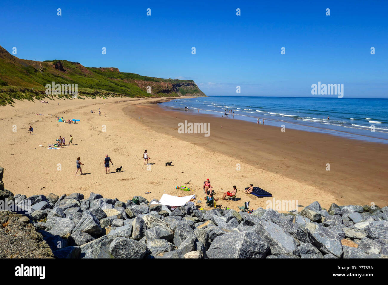 Big sandy beach on hot blue summer day as seaside town of Skinningrove ...
