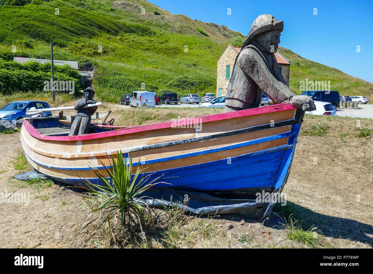 Boat sculpture of fisherman, hot blue summer day as seaside town of ...