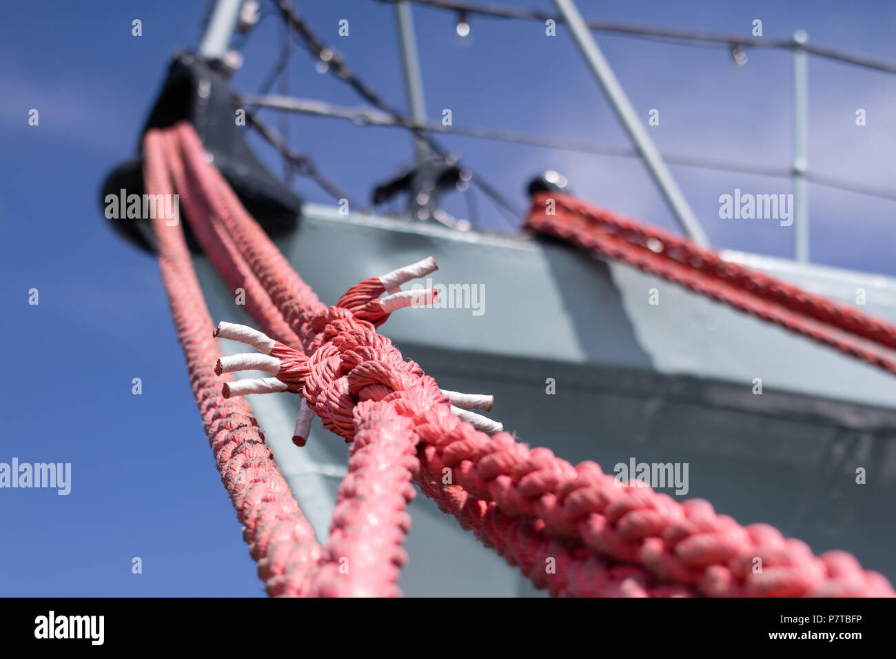 Ship mooring rope on the port wharf. Harbor bollard for large naval ...
