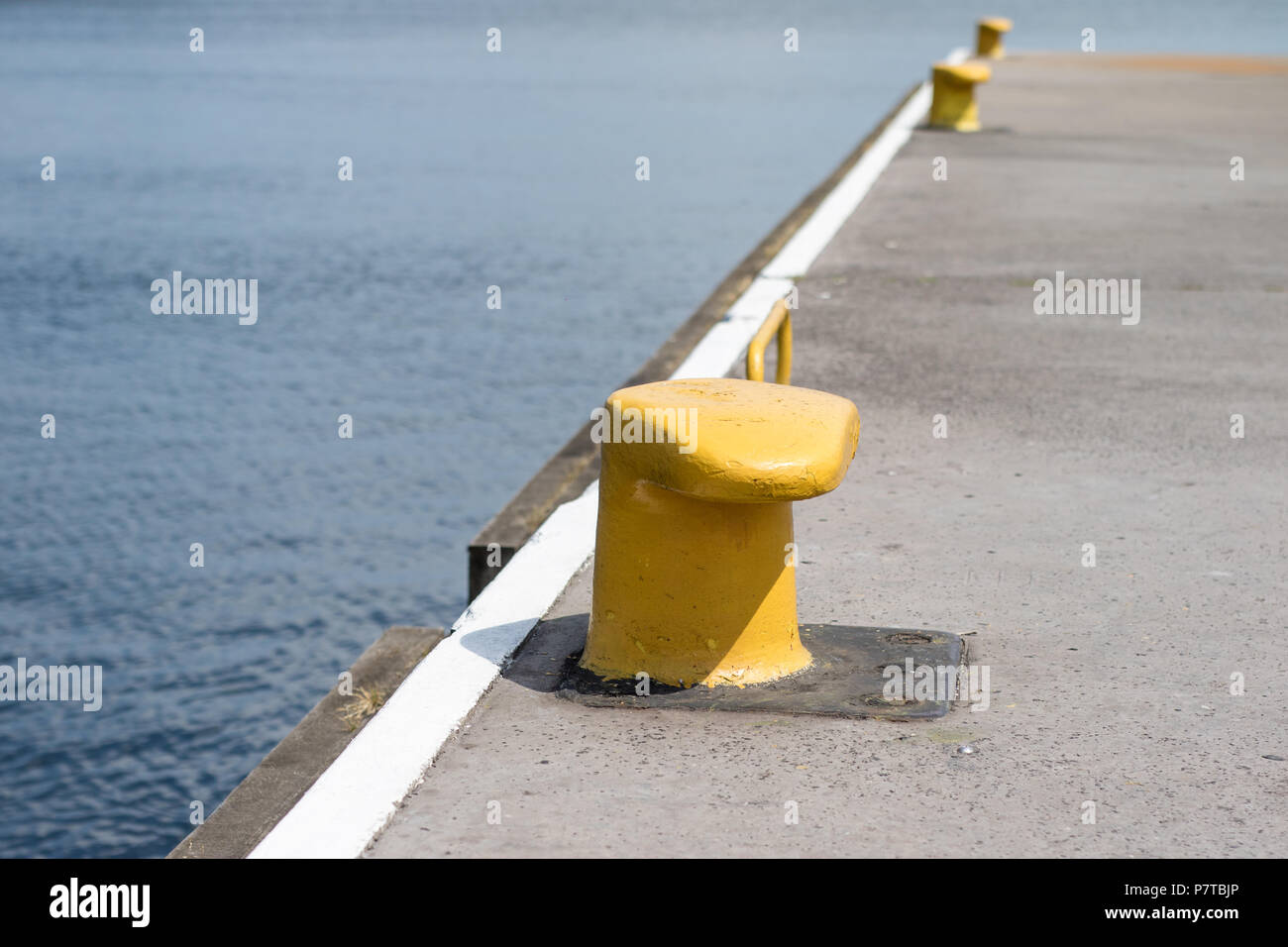Harbor bollard for large naval vessels. The port wharf in central ...