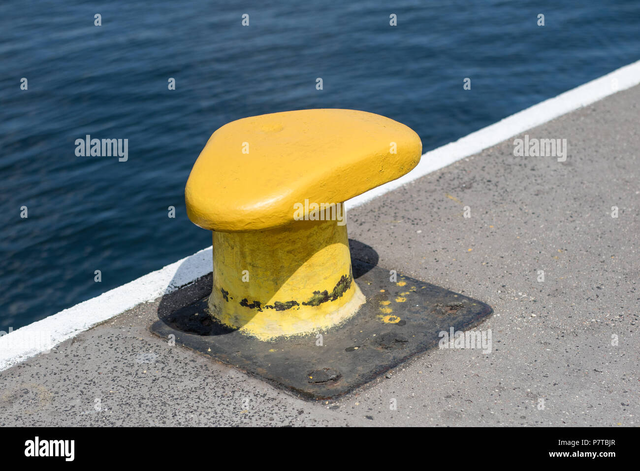 Harbor bollard for large naval vessels. The port wharf in central ...