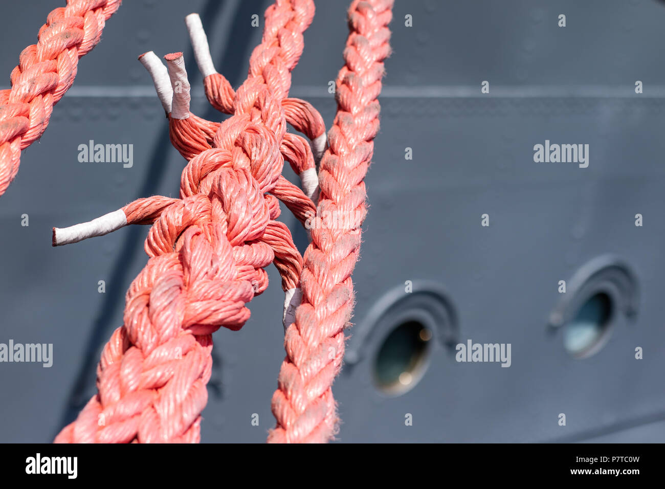 Ship mooring rope on the port wharf. Harbor bollard for large naval ...