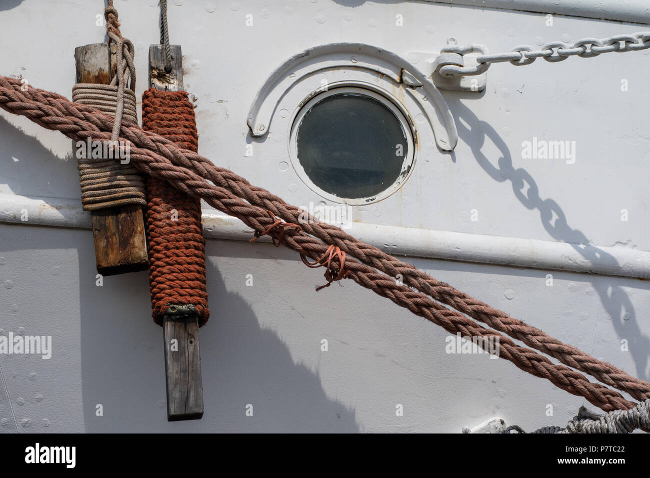 Ship mooring rope on the port wharf. Harbor bollard for large naval ...