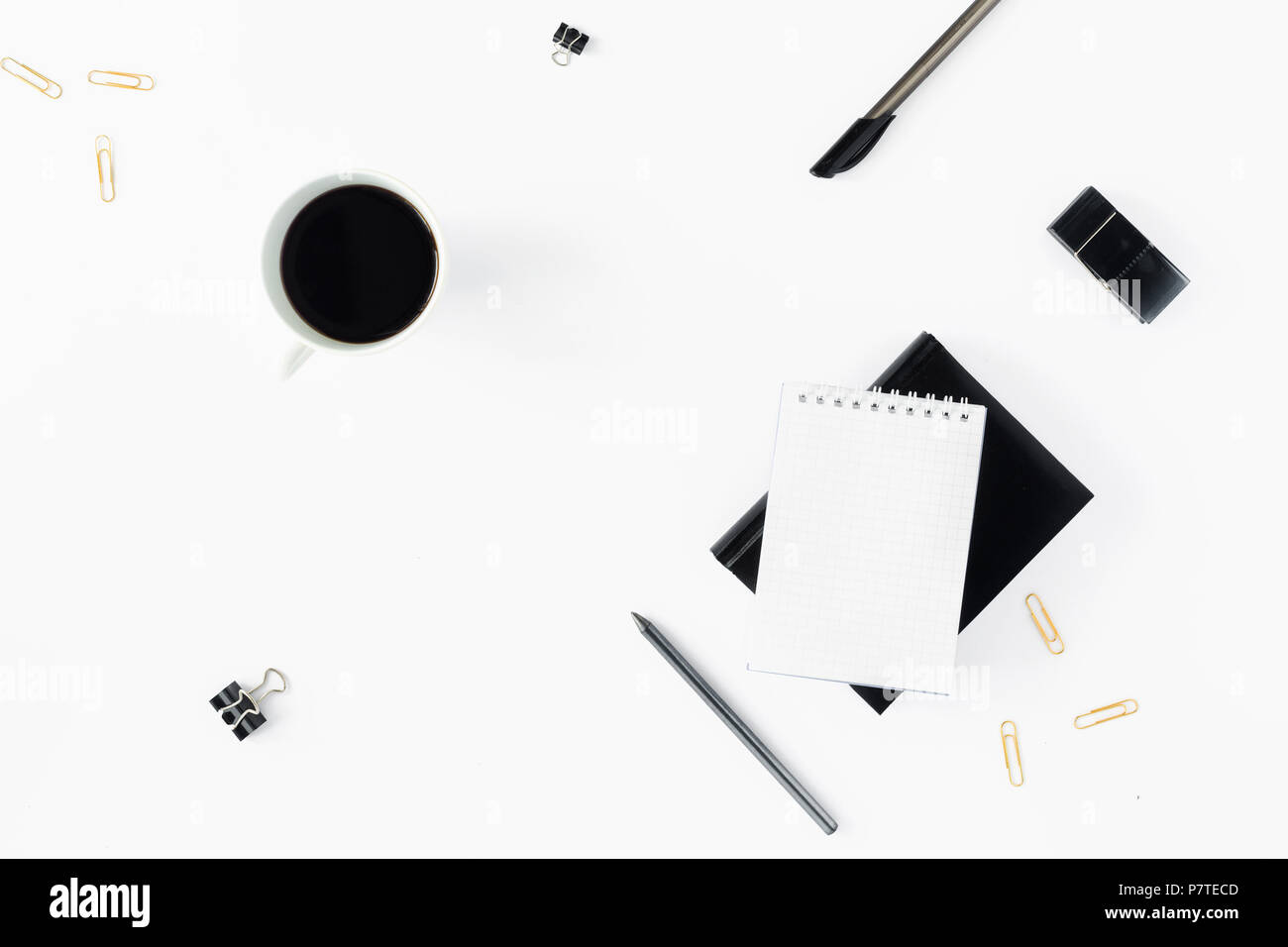 Feminine desk workspace with diary, golden clips, pen and cup of coffee ...