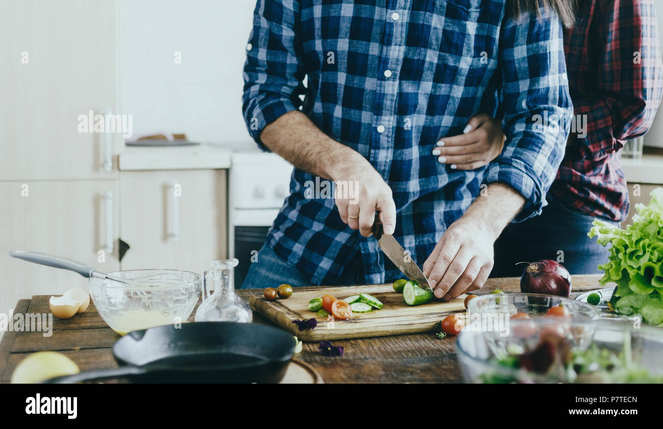 Couple cooking breakfast from vegetables at home in the kitchen Stock ...