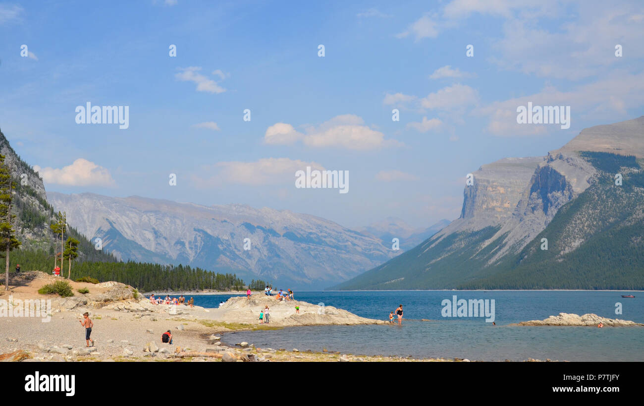 BANFF, AB / CANADA - JULY 28, 2017: Visitors enjoy the beach of Lake ...