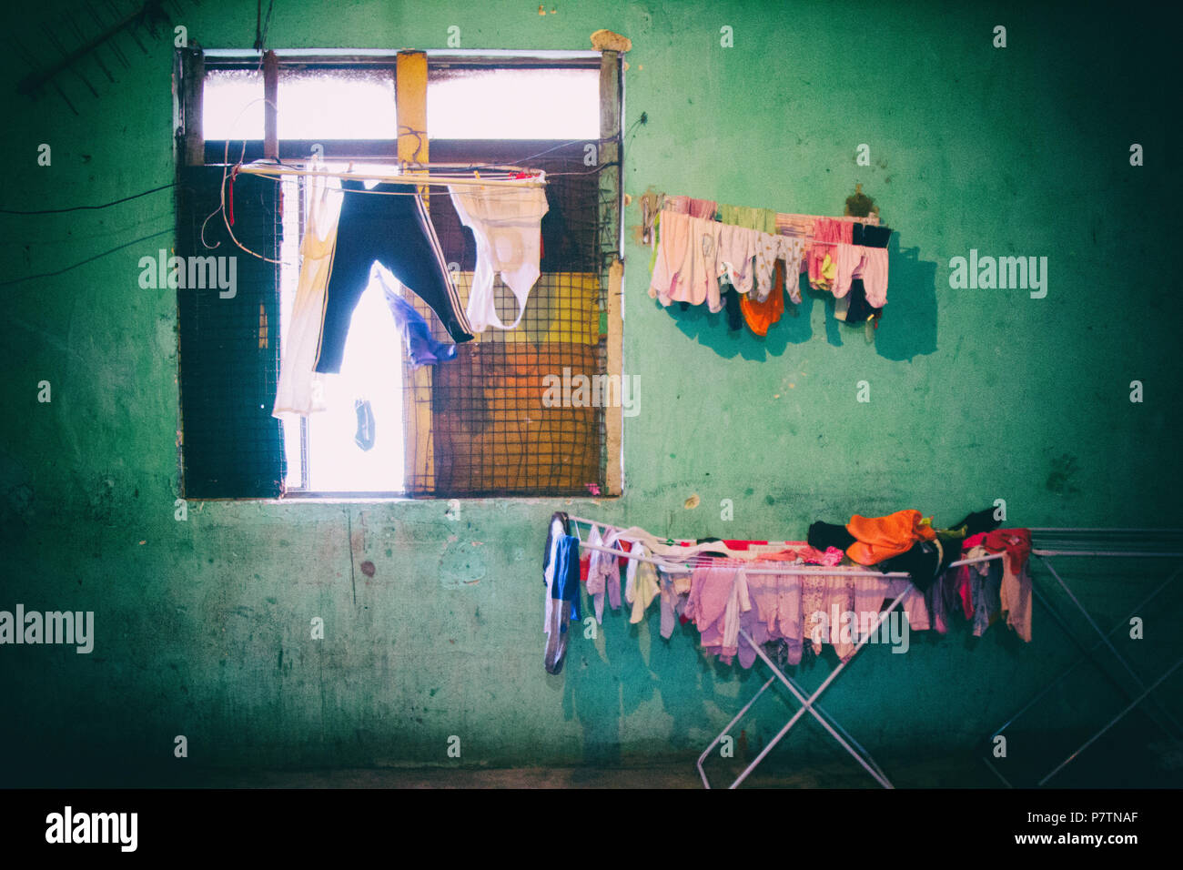 Drying clothes near a window of a decayed occupied building Stock Photo ...