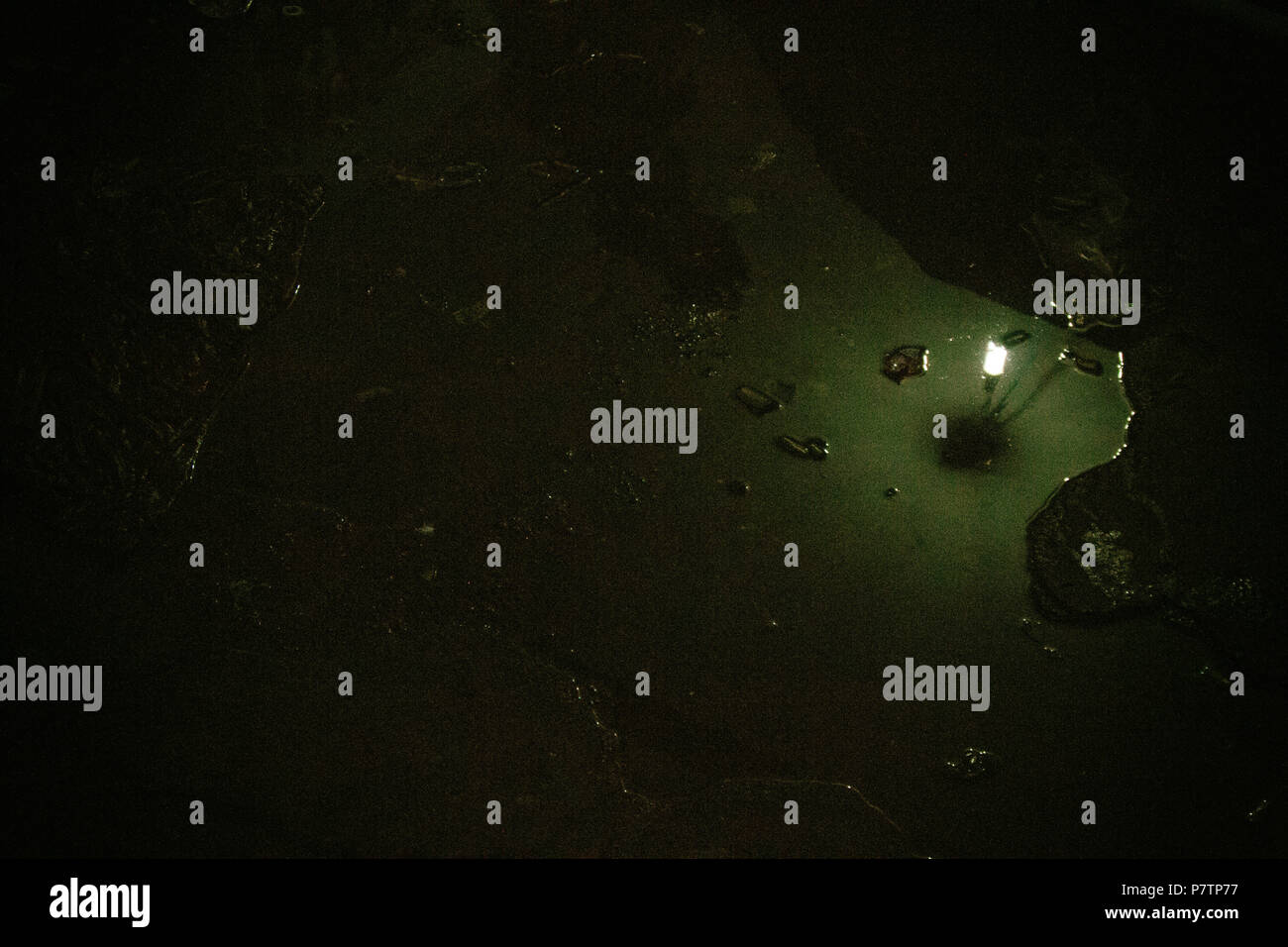 Light bulb reflection on a puddle. No people Stock Photo - Alamy