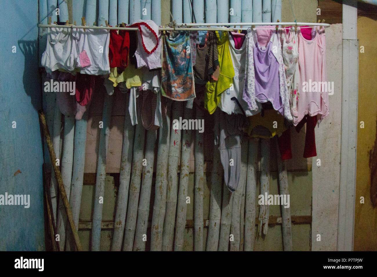 Children clothes hanged to dry in front of a decayed wall Stock Photo ...
