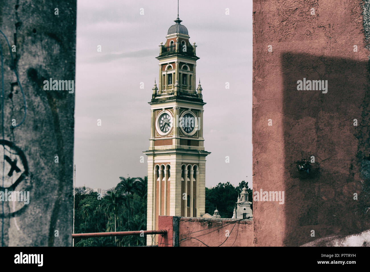 Clock tower behind shabby walls Stock Photo - Alamy