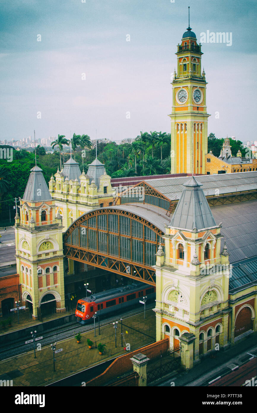 Red train leaving the station Stock Photo - Alamy