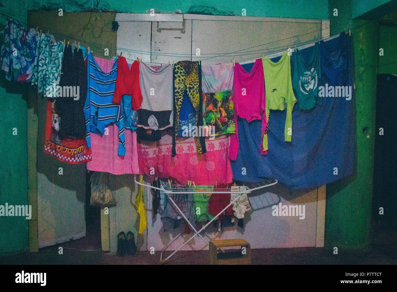 Colorful clothes in a vertical slum Stock Photo - Alamy